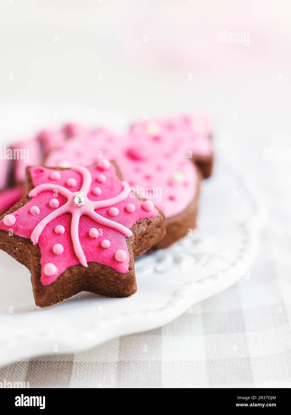 Chocolate Christmas biscuits with pink icing Stock Photo - Alamy