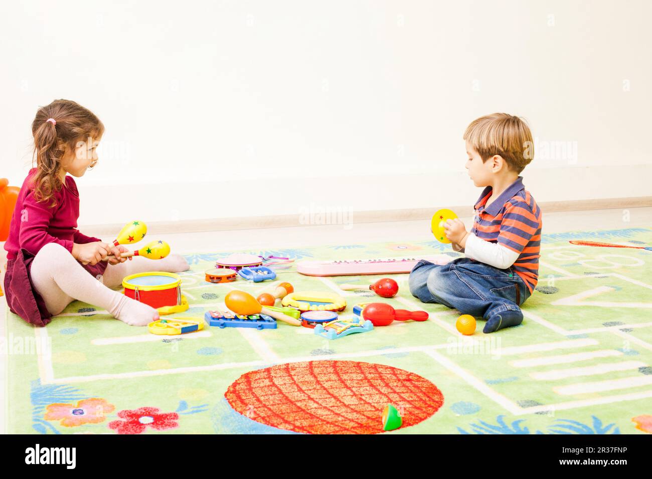 Kids playing with toys Stock Photo - Alamy