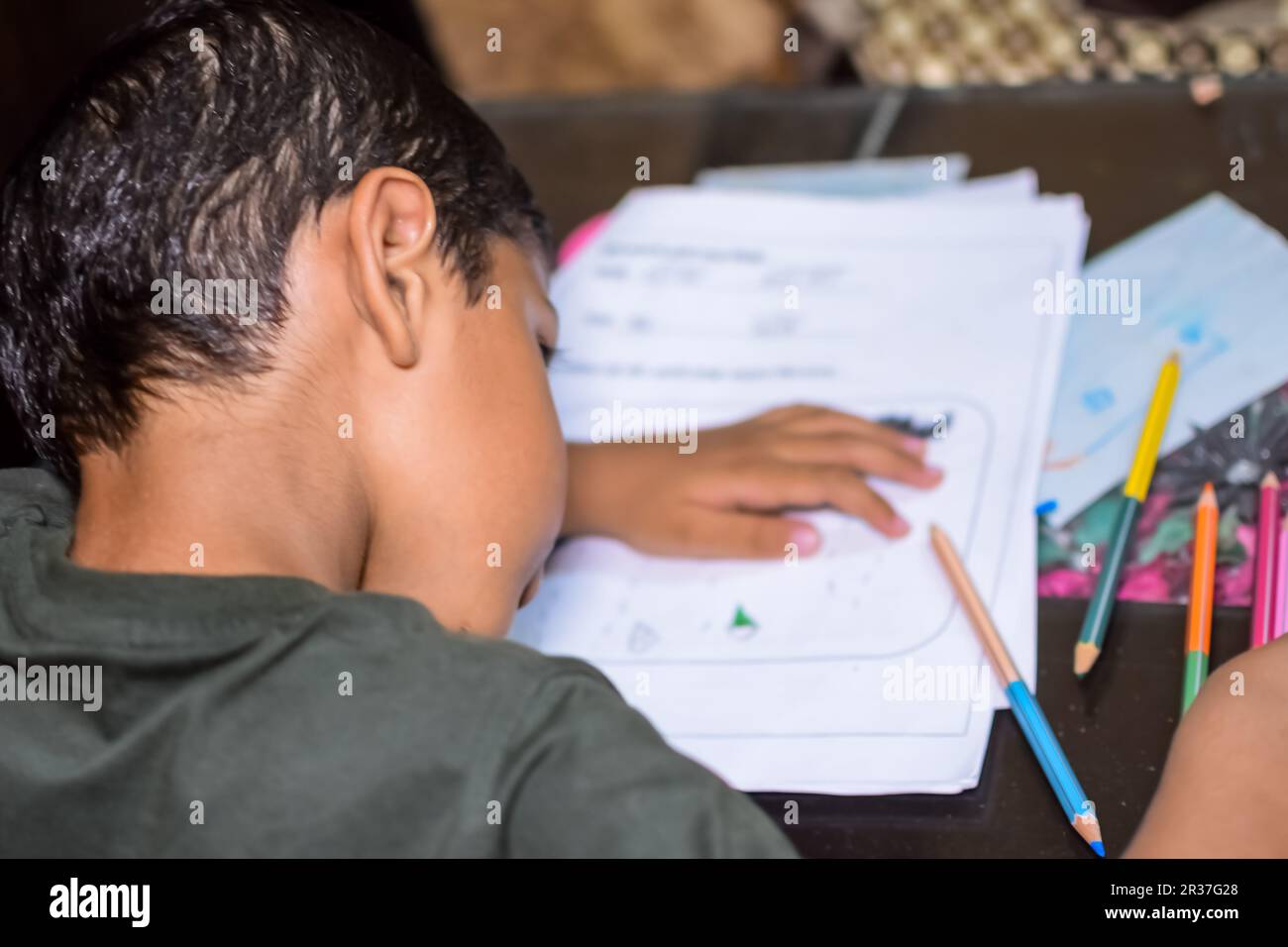 Smart Indian little boy drawing with colourful pencils kit of various ...