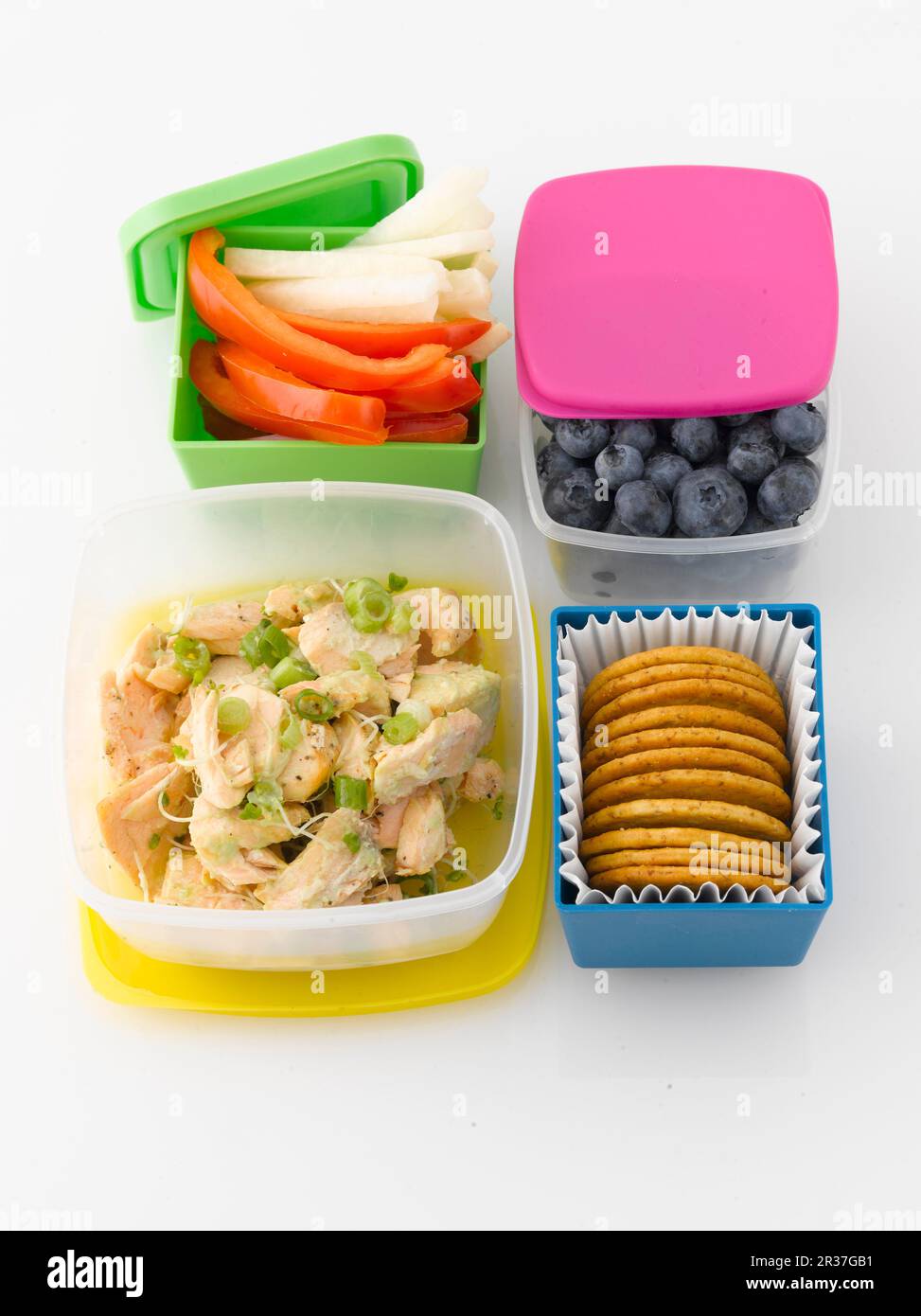 A packed lunch with chicken, vegetables, blueberries and crackers Stock ...