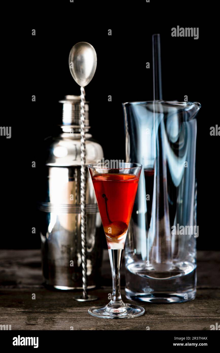 A glass of homemade cherry brandy with bar utensils Stock Photo - Alamy