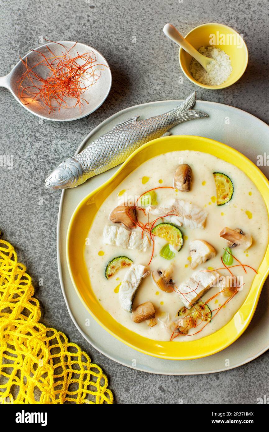 Sea bass stew with courgette and mushrooms Stock Photo - Alamy