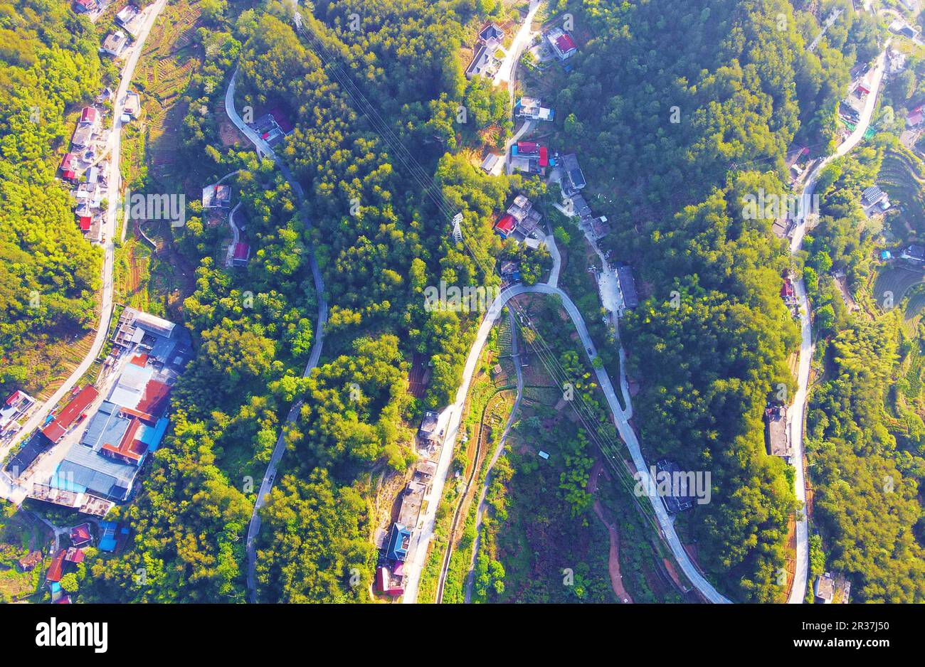 ANQING, CHINA - MAY 23, 2023 - A winding mountain road connects ...