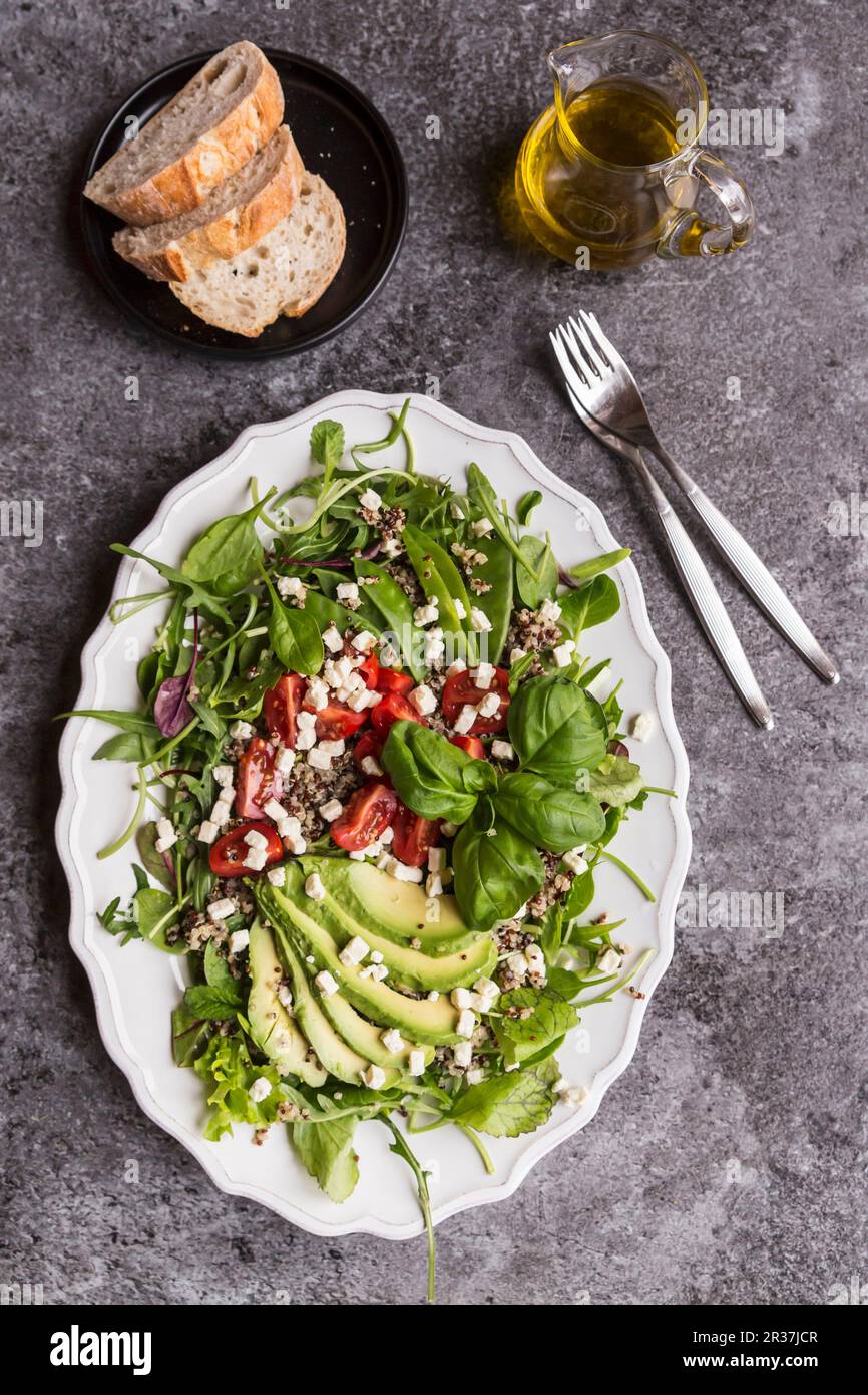 Quinoa salad with rocket, avocado, feta cubes, sugar snaps and tomatoes ...