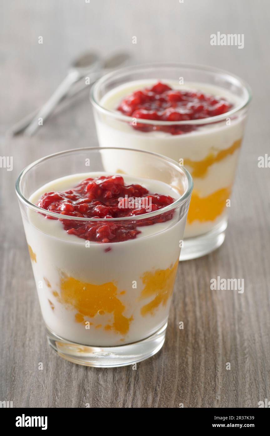 Yoghurt desserts with lemon curd and raspberry puree Stock Photo - Alamy