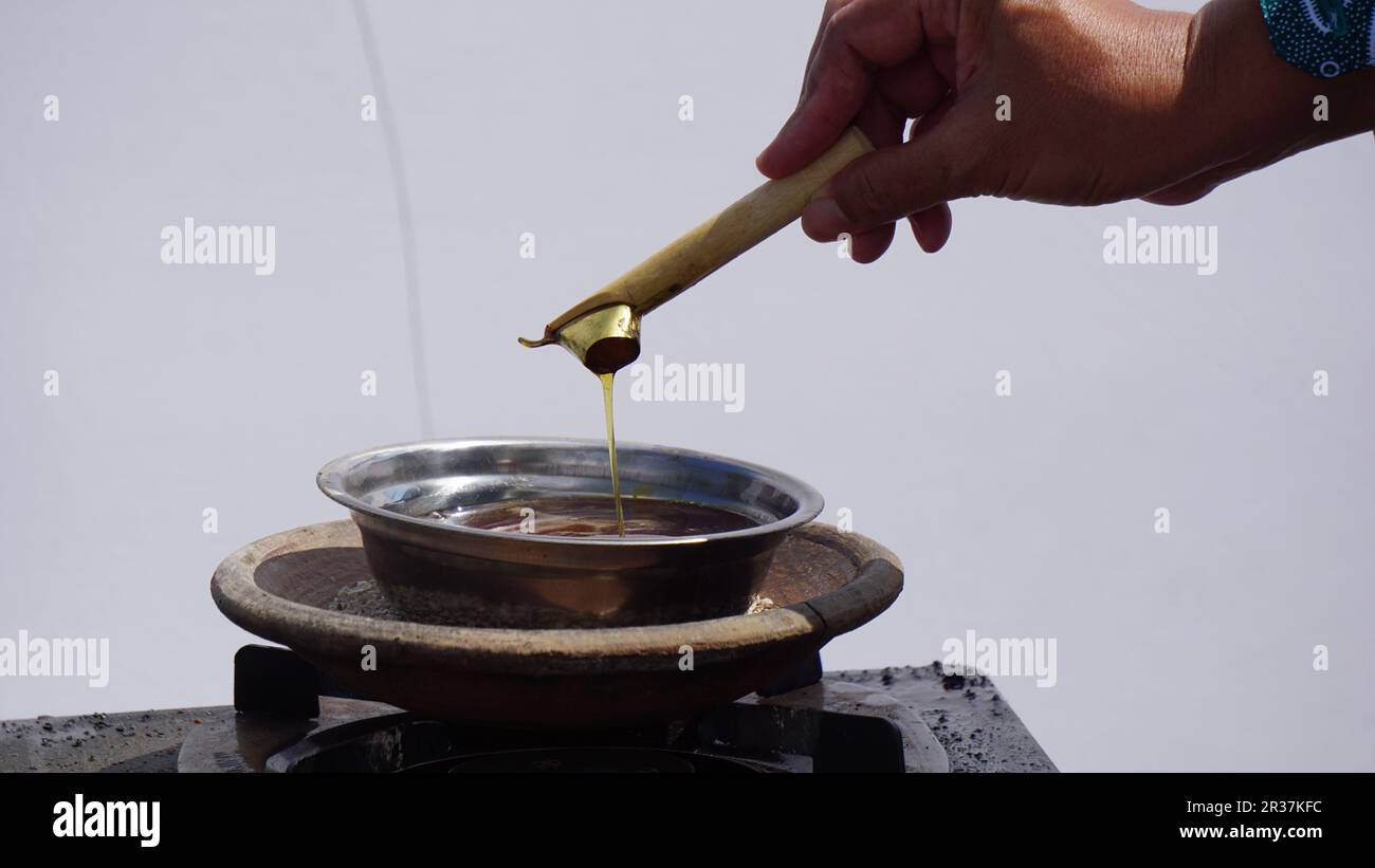 The wax (Indonesian call it malam) melts in the pan. This wax is used ...