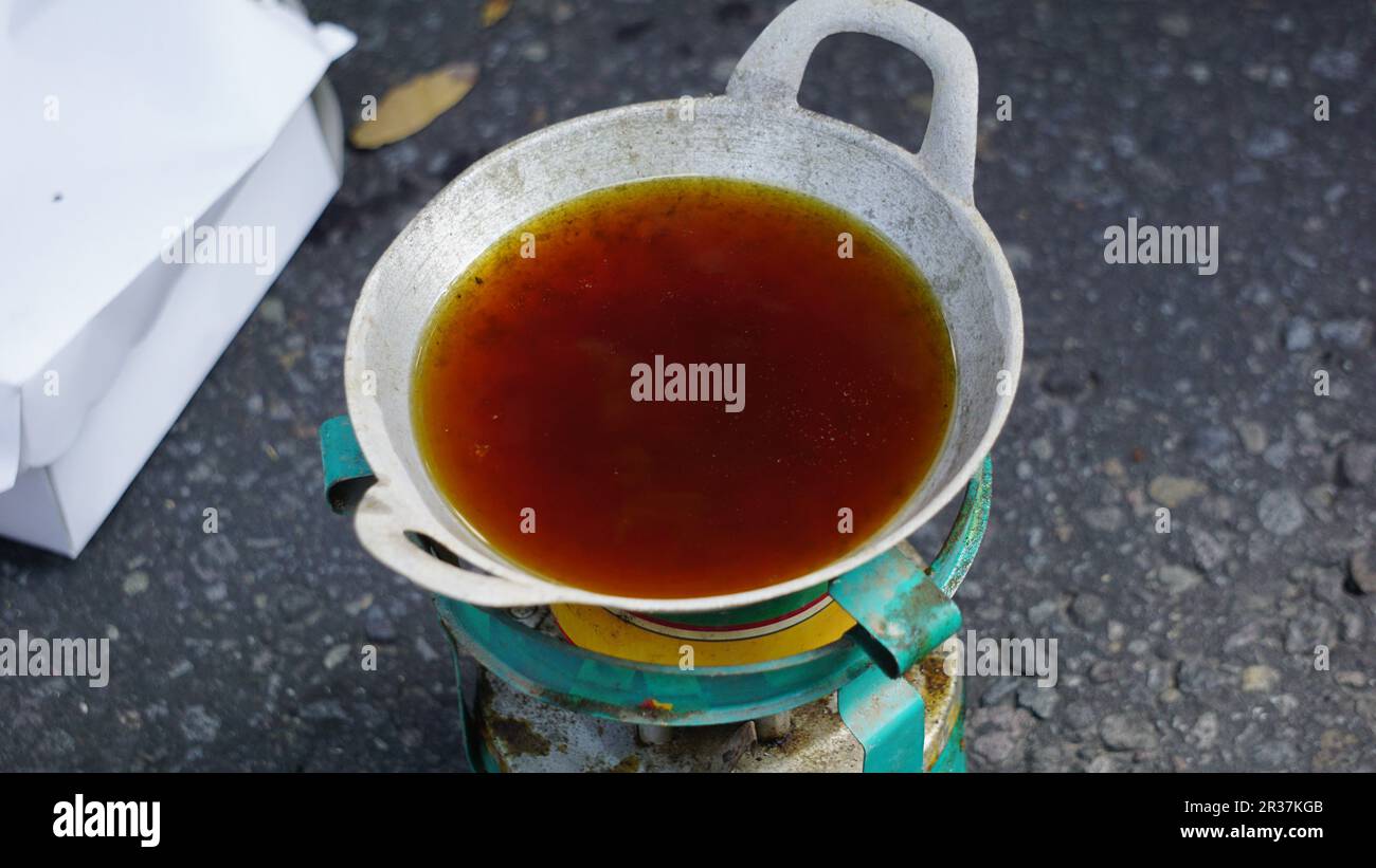 The wax (Indonesian call it malam) melts in the pan. This wax is used ...