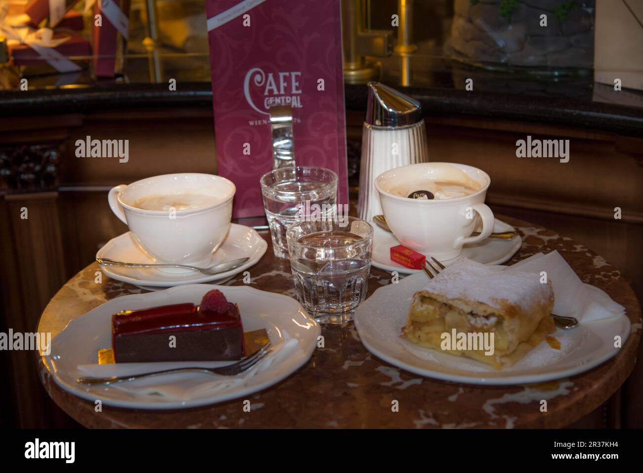 Cafe table with melange, Viennese coffee speciality, apple strudel and ...