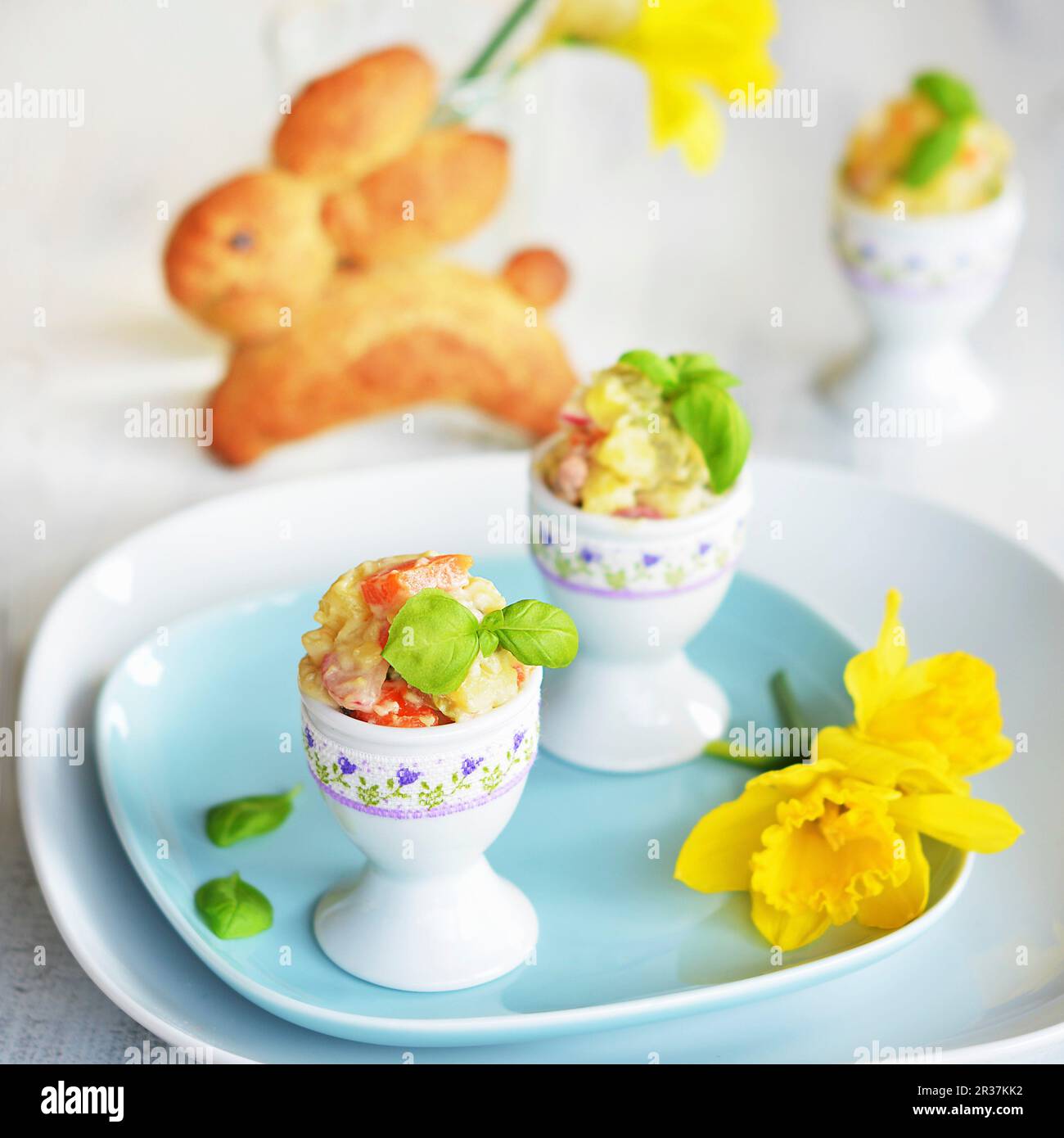 Potato salad with carrot, apple, peas and mayonnaise served in egg cups ...