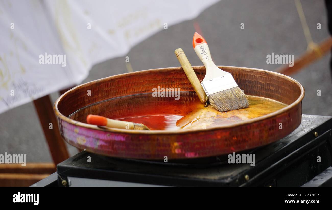 The wax (Indonesian call it malam) melts in the pan. This wax is used ...
