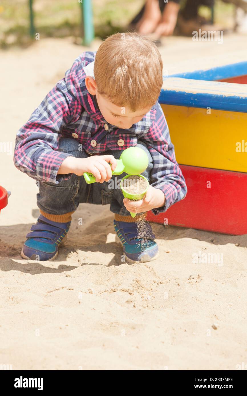 Boy and girl playing sandbox hi-res stock photography and images - Alamy
