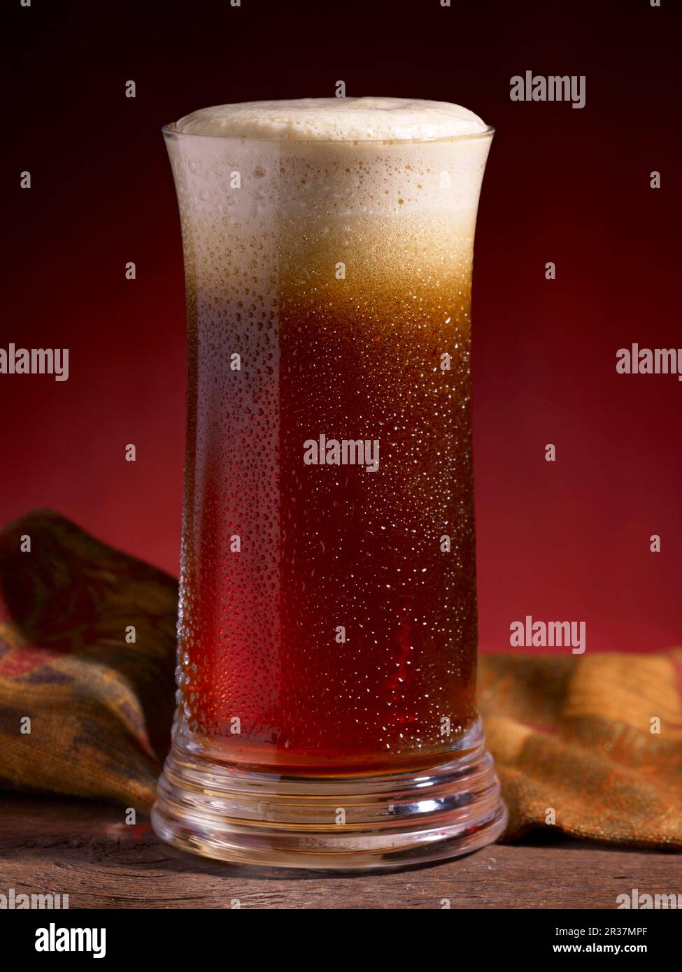 A glass of cold ale with foam on top Stock Photo - Alamy