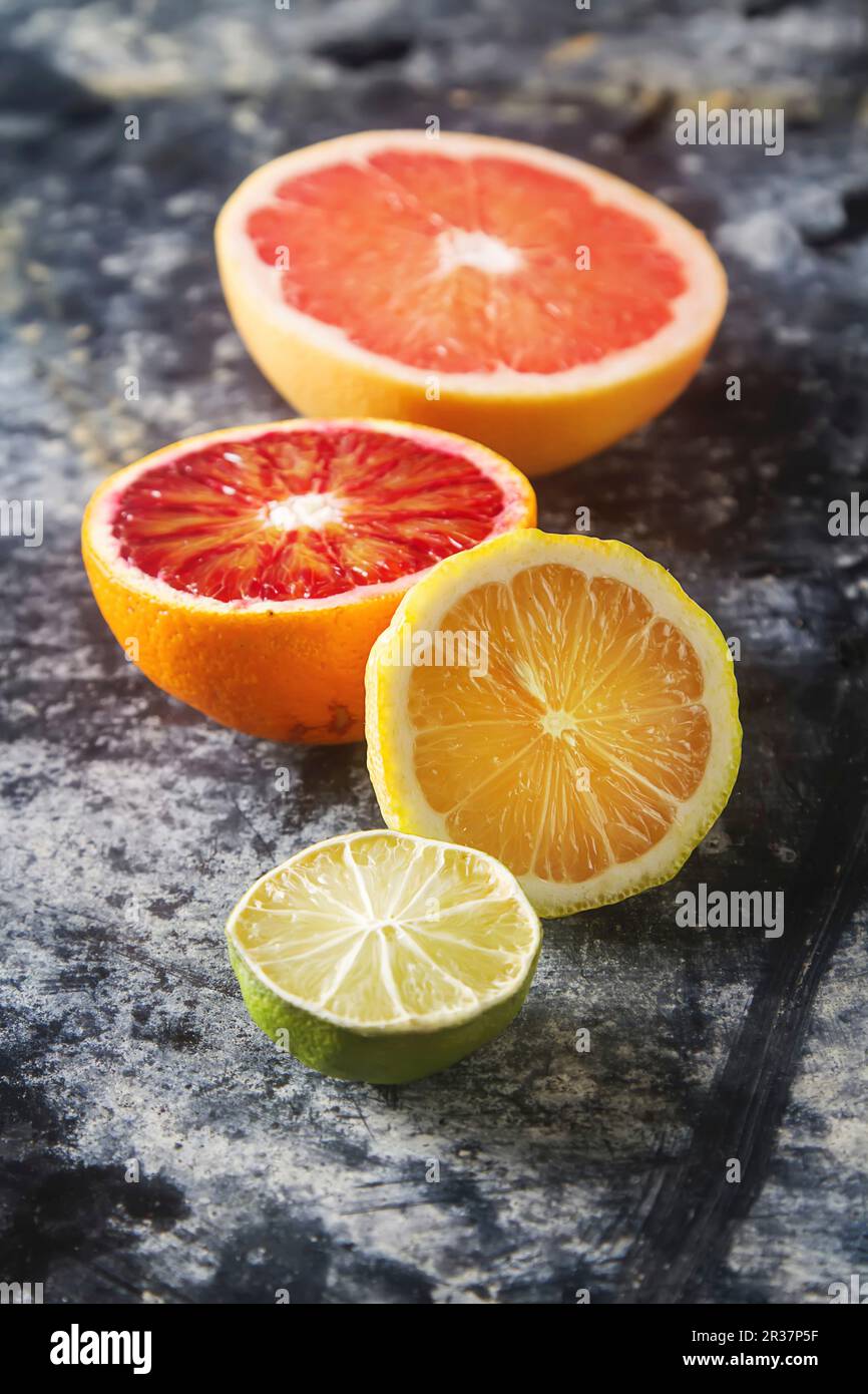 Assorted citrus fruit, halved Stock Photo - Alamy