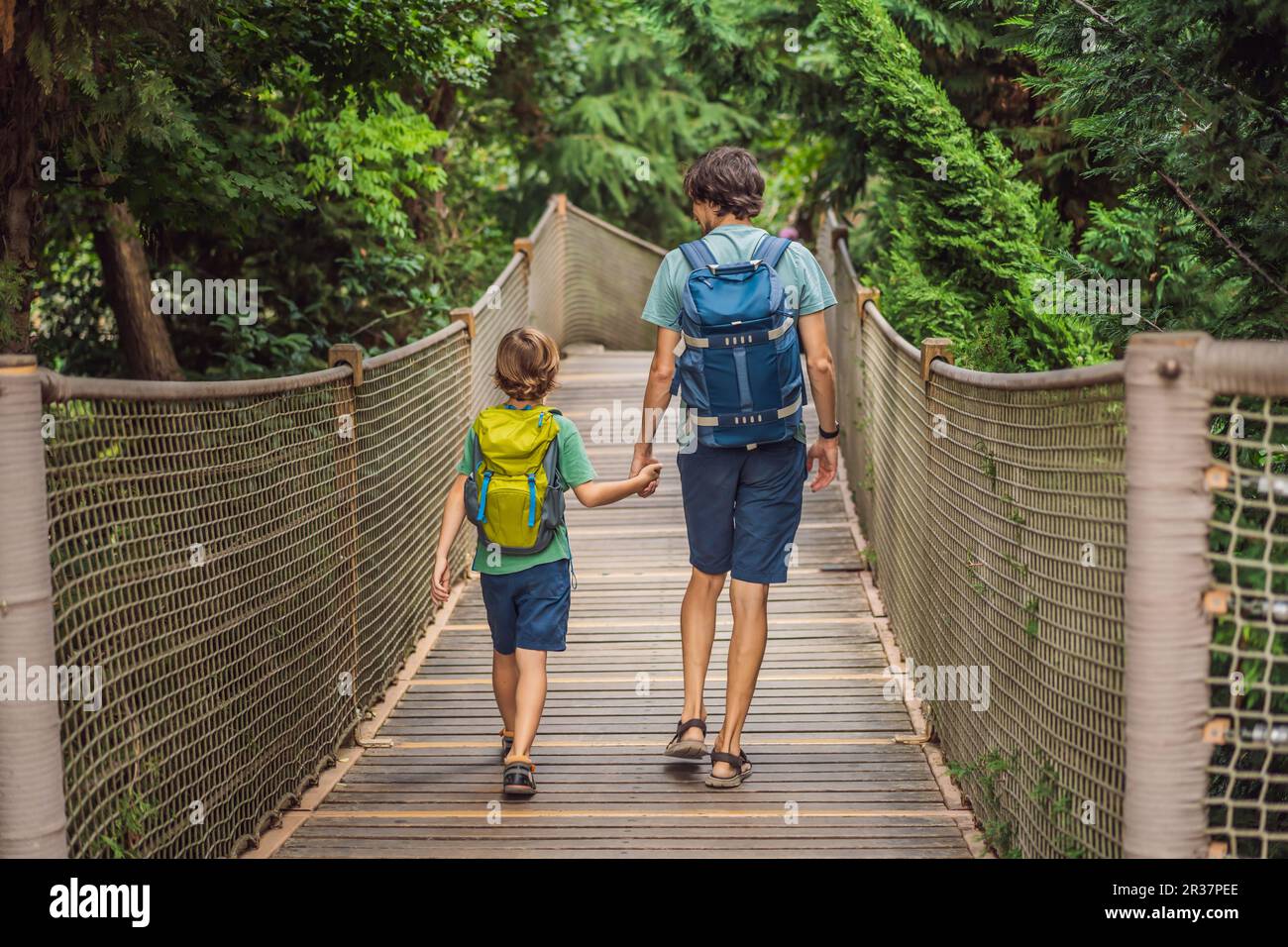 father and son tourists in Rope bridge in Yildiz Park. Besiktas ...