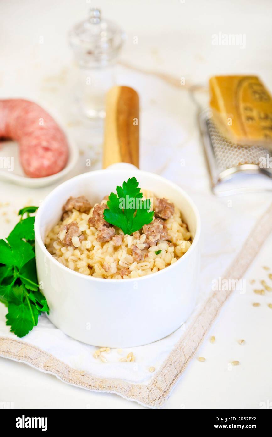 Barley risotto with sausage and parmesan Stock Photo - Alamy