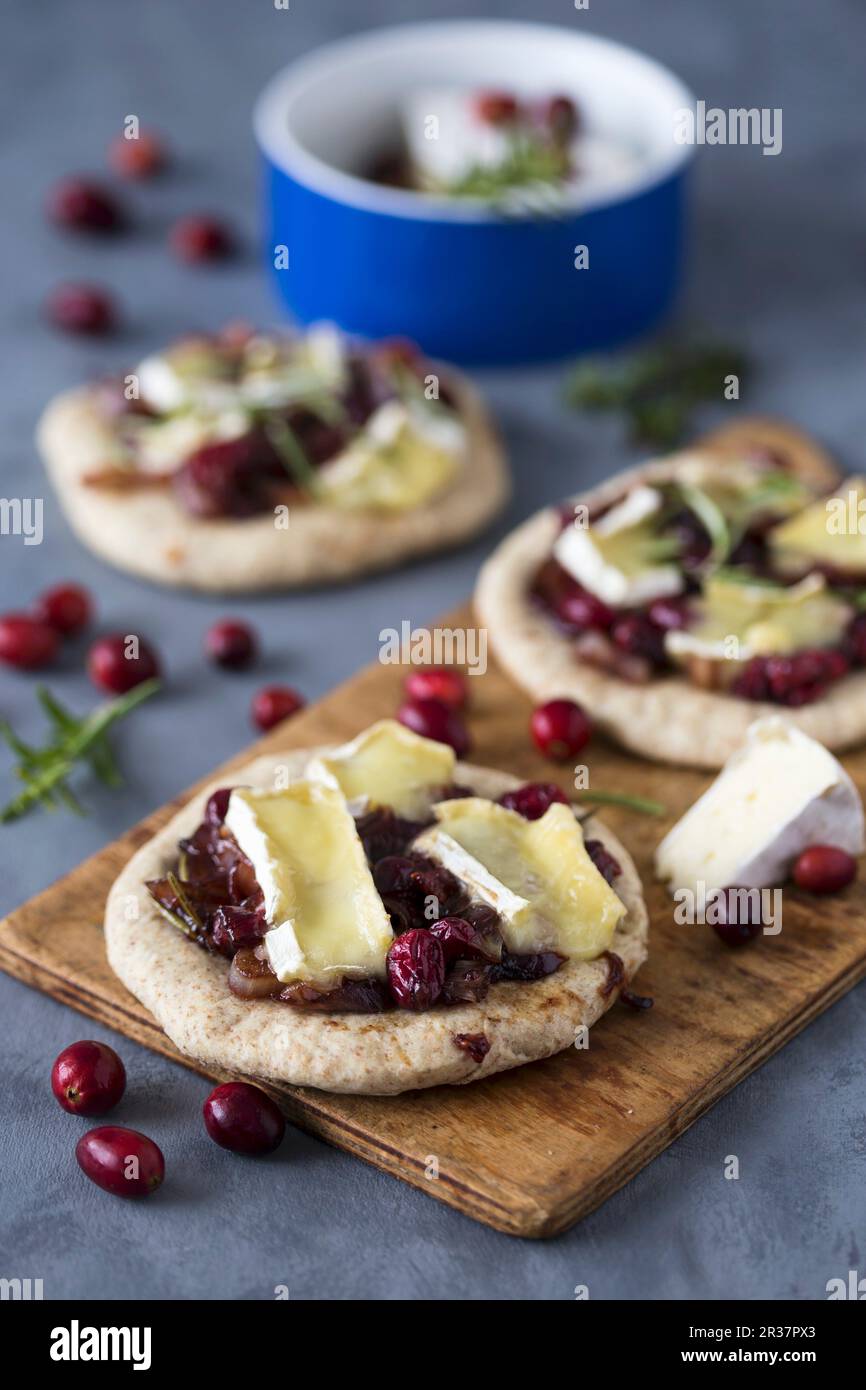 Whole grain mini pizza with cranberry and camembert cheese Stock Photo ...
