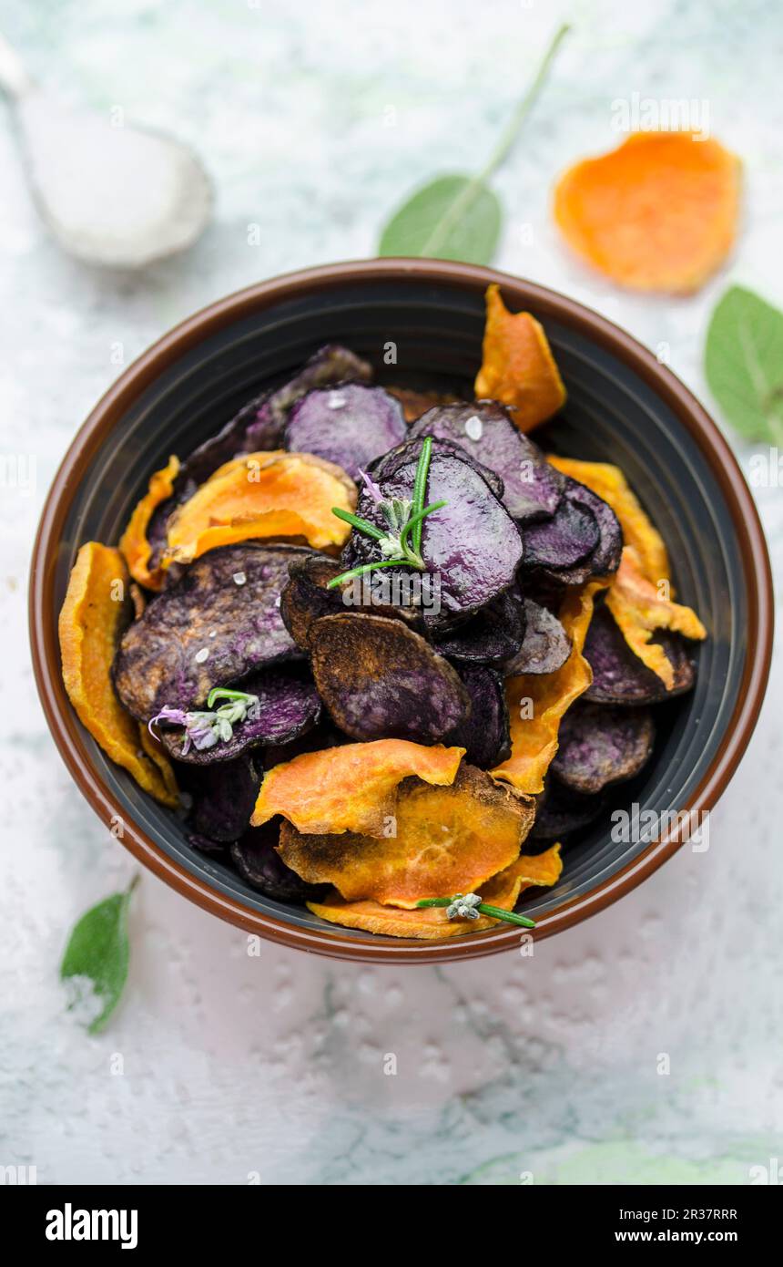 Homemade sweet potato and blue potato crisps Stock Photo - Alamy