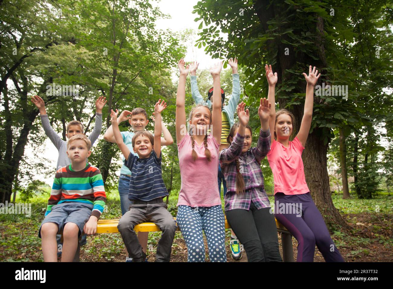 Group of children on a park bench Stock Photo - Alamy