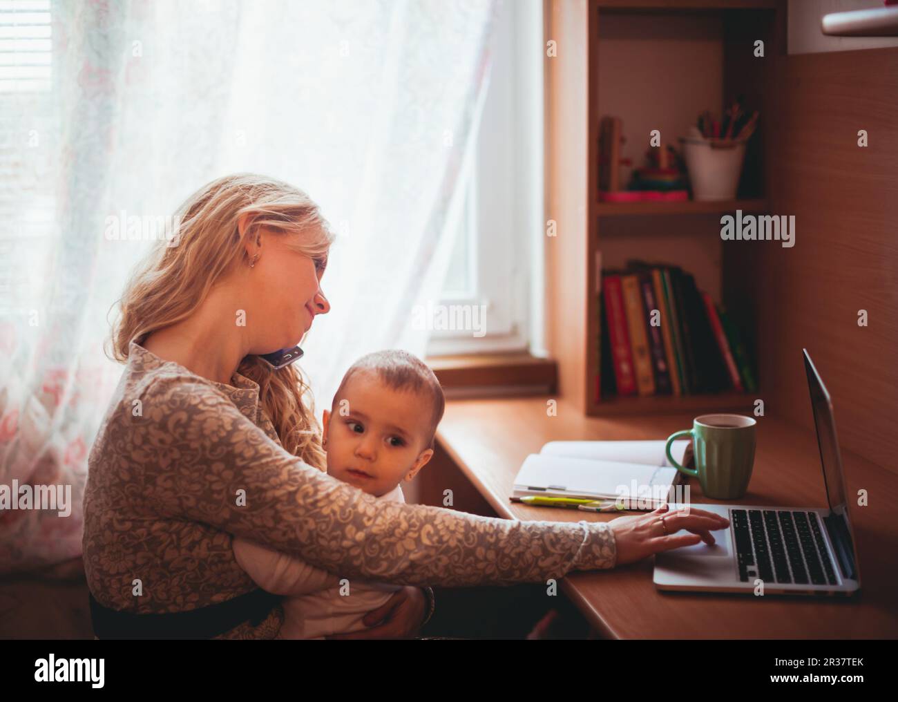 Working mom and baby hi-res stock photography and images - Alamy