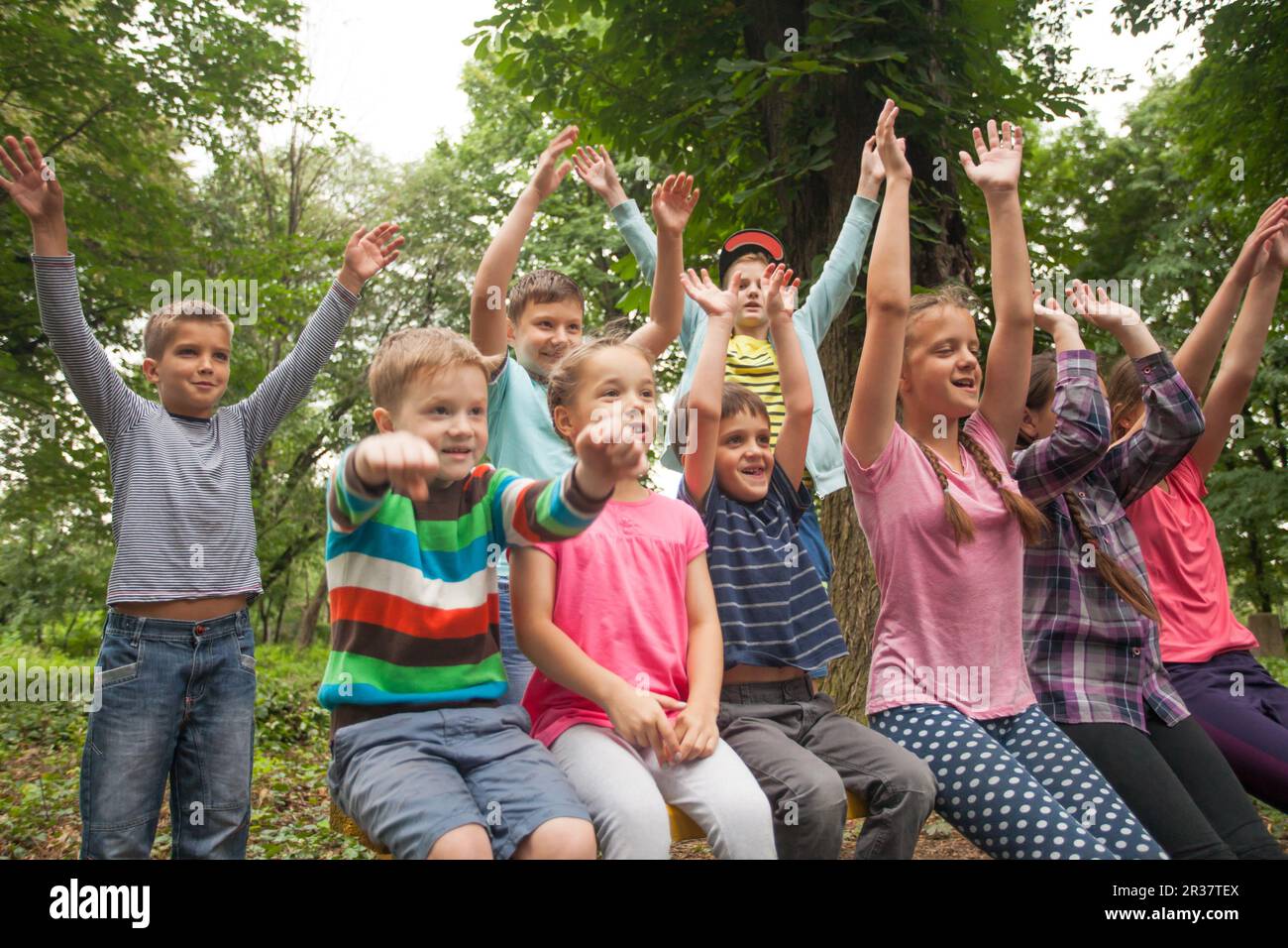 Group of children on a park bench Stock Photo - Alamy