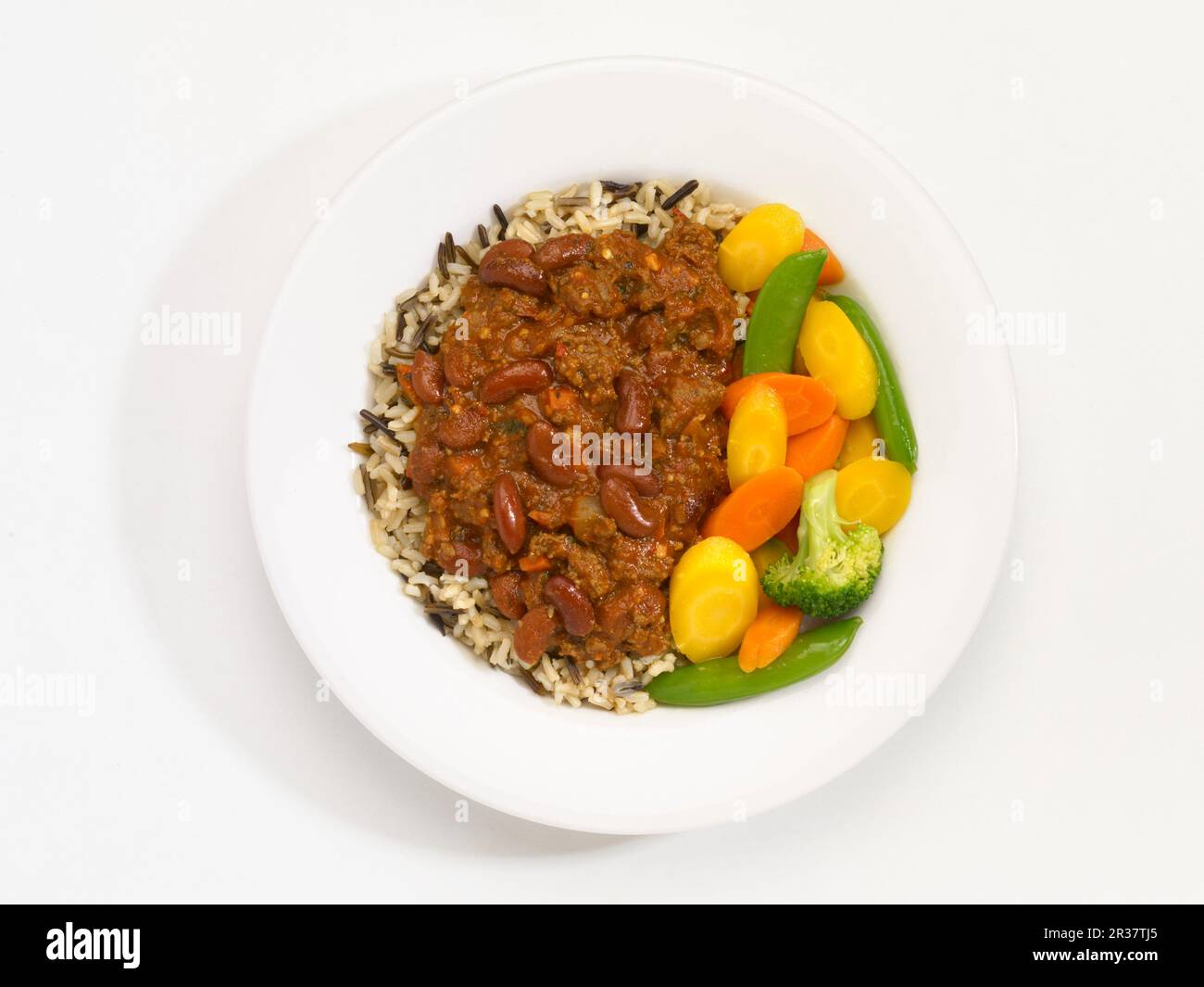 Low-fat chilli with vegetables and rice on a plate in front of a white ...