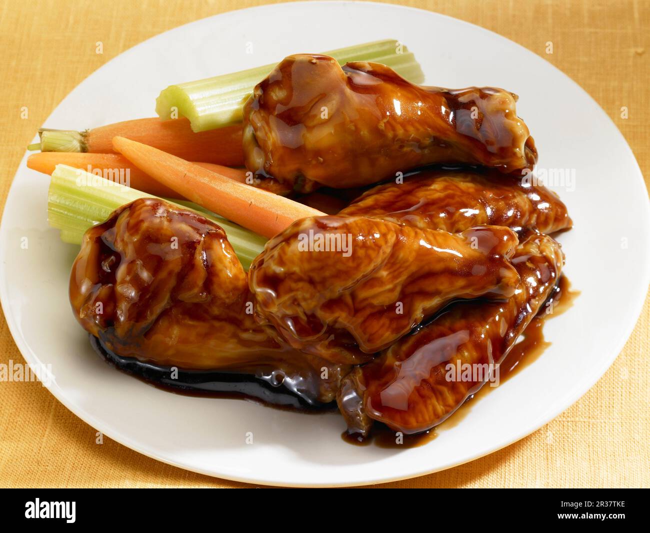 Glazed chicken legs with carrots and celery (Asia Stock Photo - Alamy