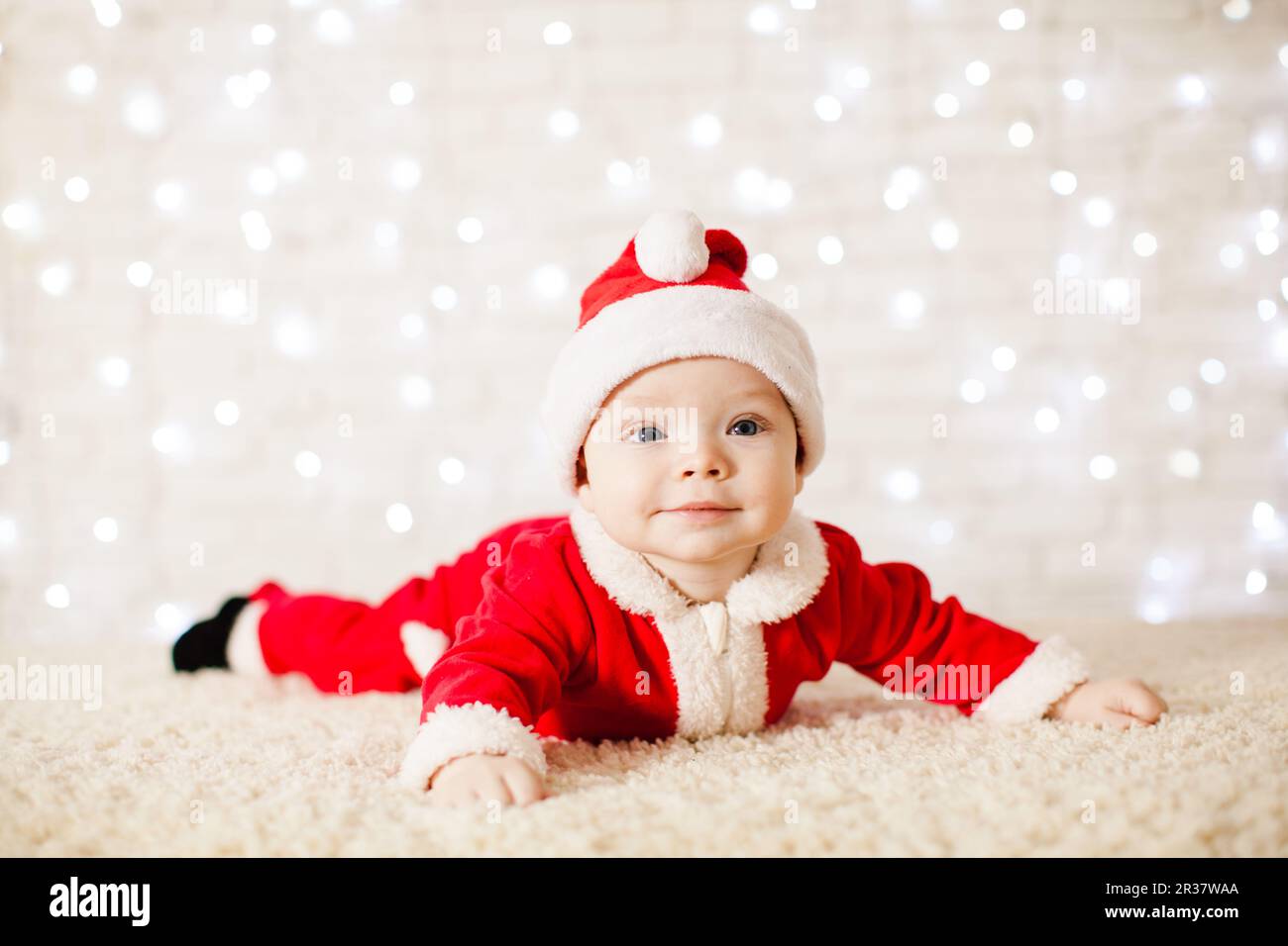 Little Santa baby Stock Photo - Alamy