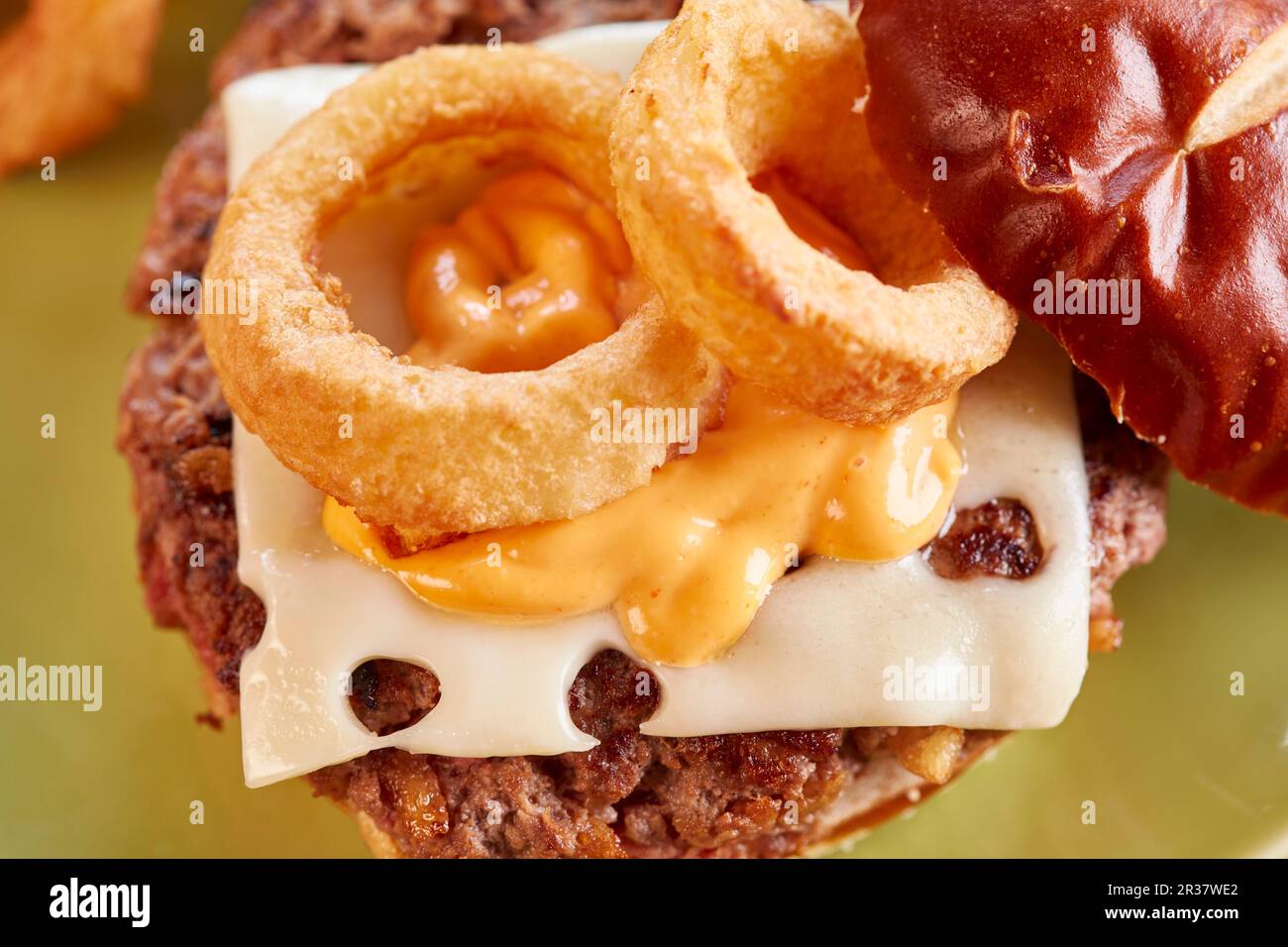 Teriyaki burger with emmental and onion rings Stock Photo - Alamy