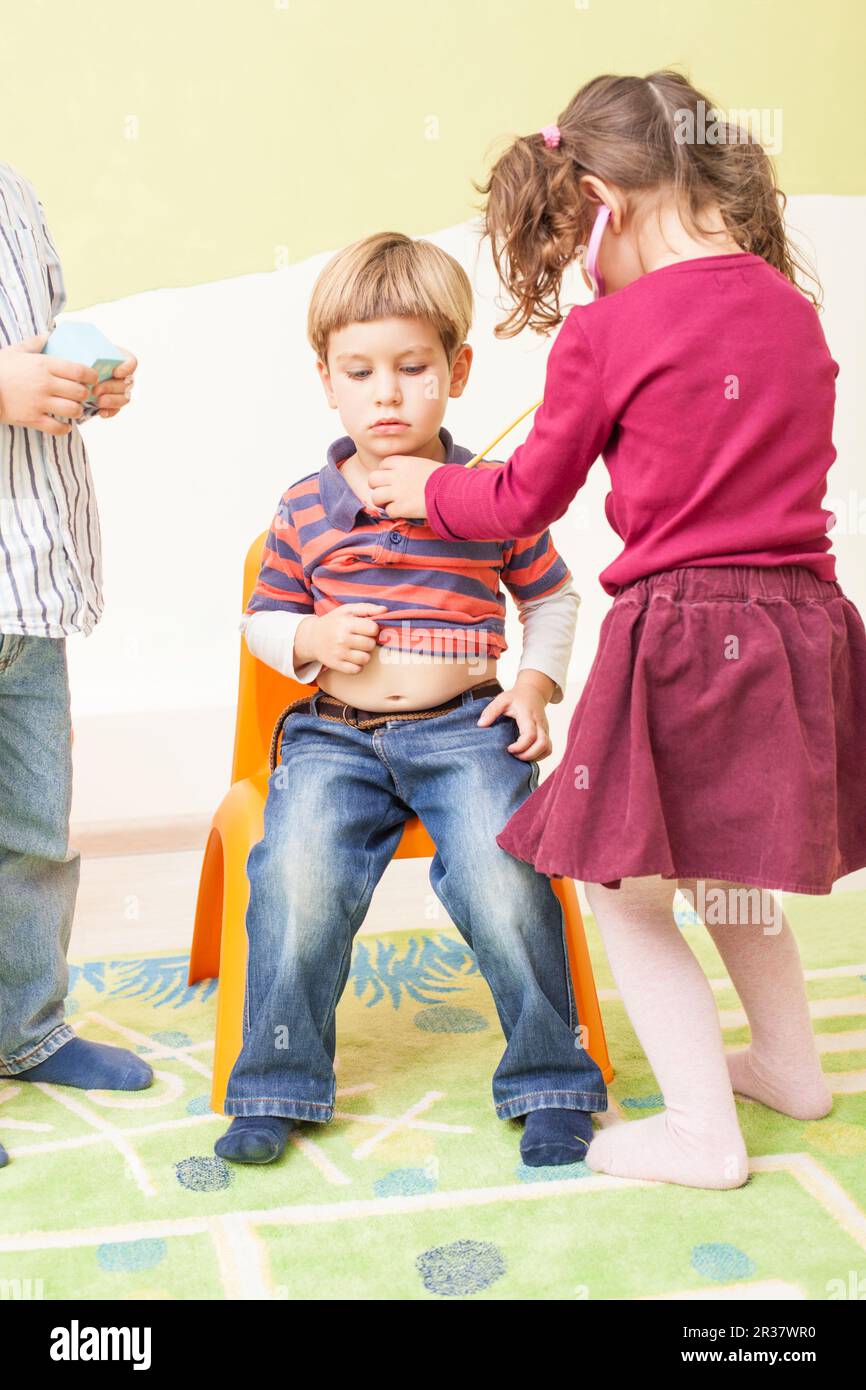 Children playing doctor and patient Stock Photo - Alamy