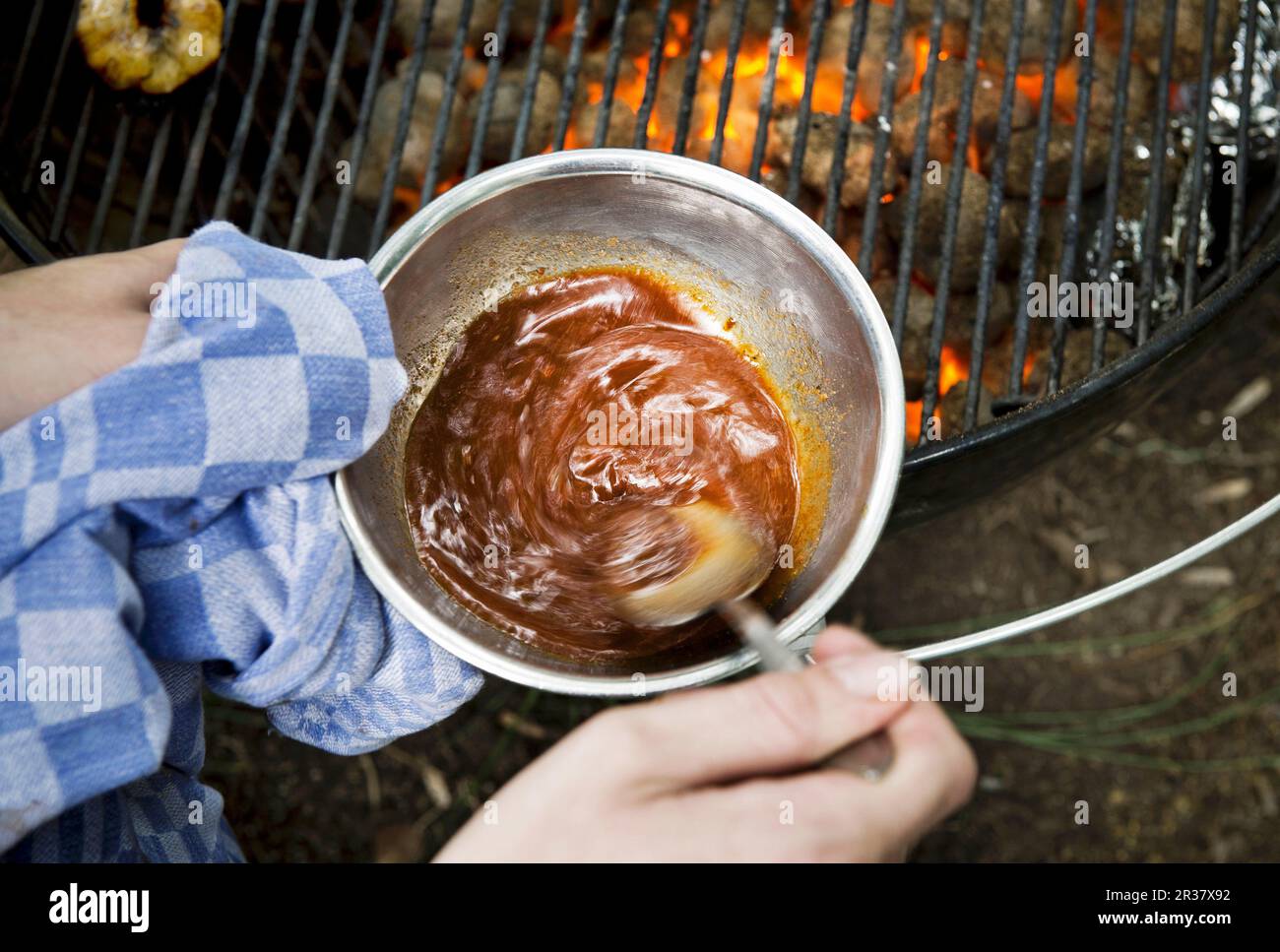 Babi Pangang sauce being heated on a grill Stock Photo - Alamy