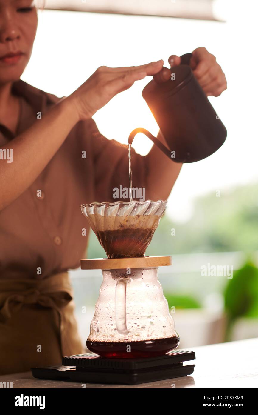 Barista making pour over coffee for customer Stock Photo - Alamy
