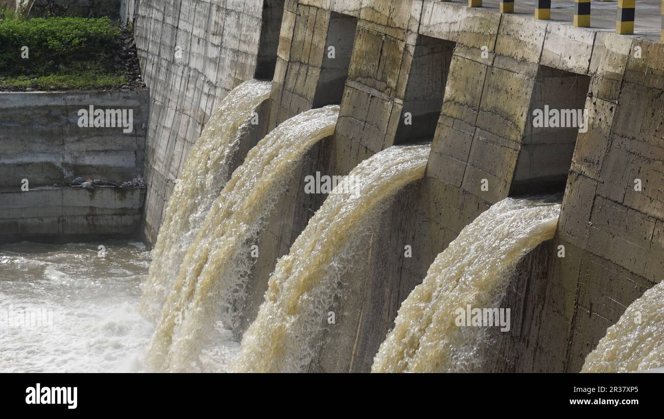 River water flows through the dam Stock Photo - Alamy