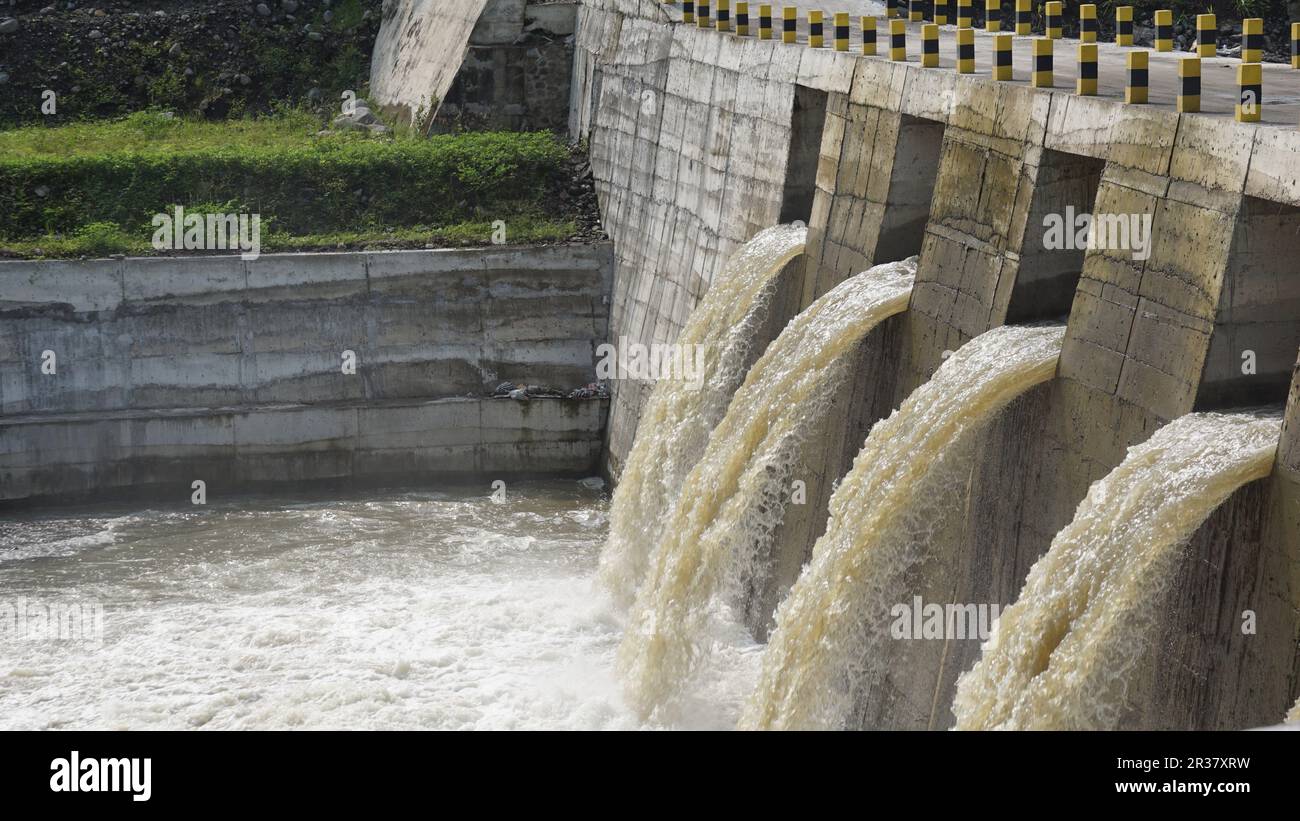 River water flows through the dam Stock Photo - Alamy