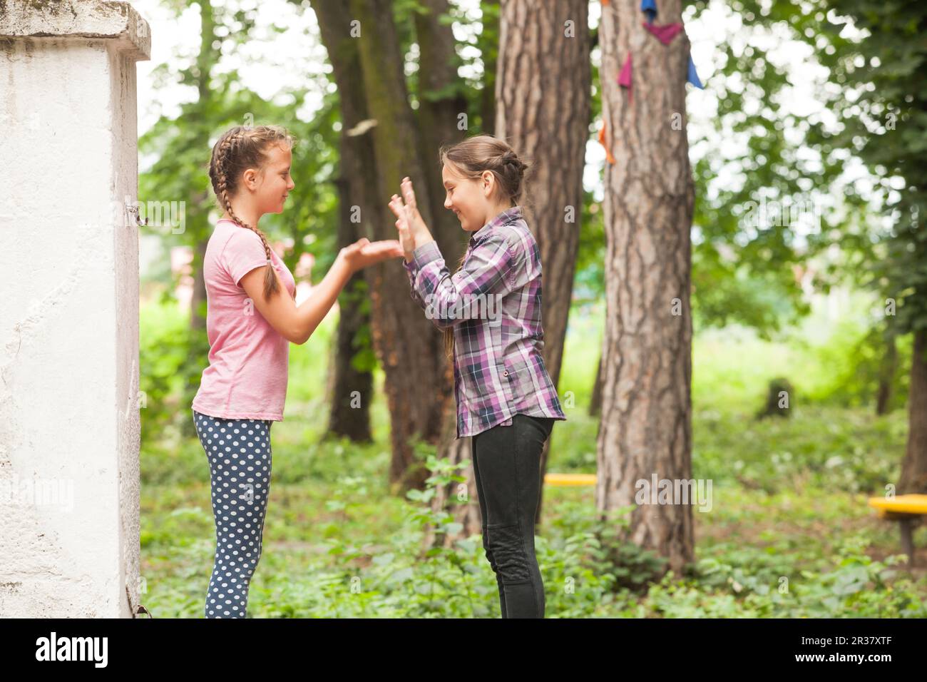 Two young girls playing outside hi-res stock photography and images - Alamy