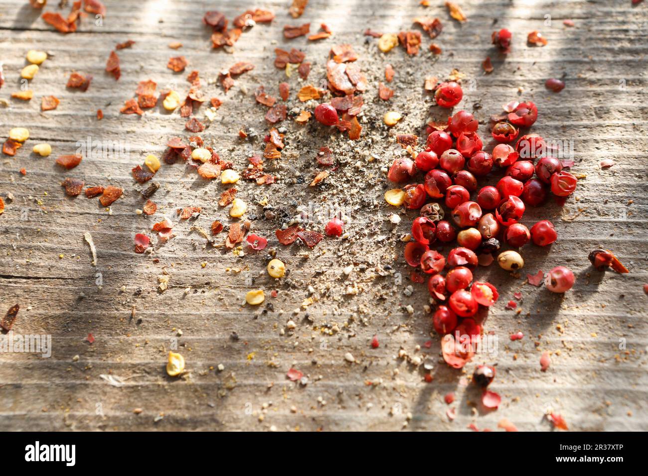 Whole pink peppercorns, ground black pepper and chilli flakes Stock ...