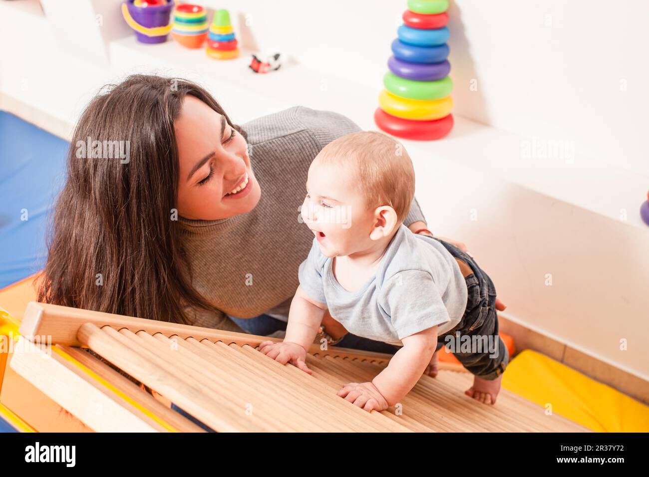 Interaction between mother and baby Stock Photo - Alamy