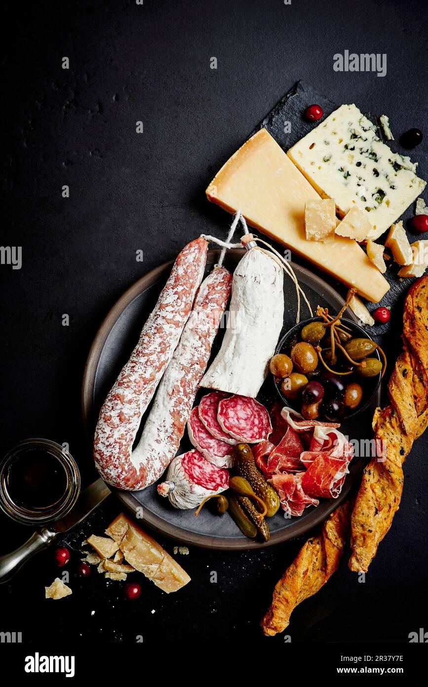 A mixed antipasti platter with olives, capers, prosciutto, dried ...