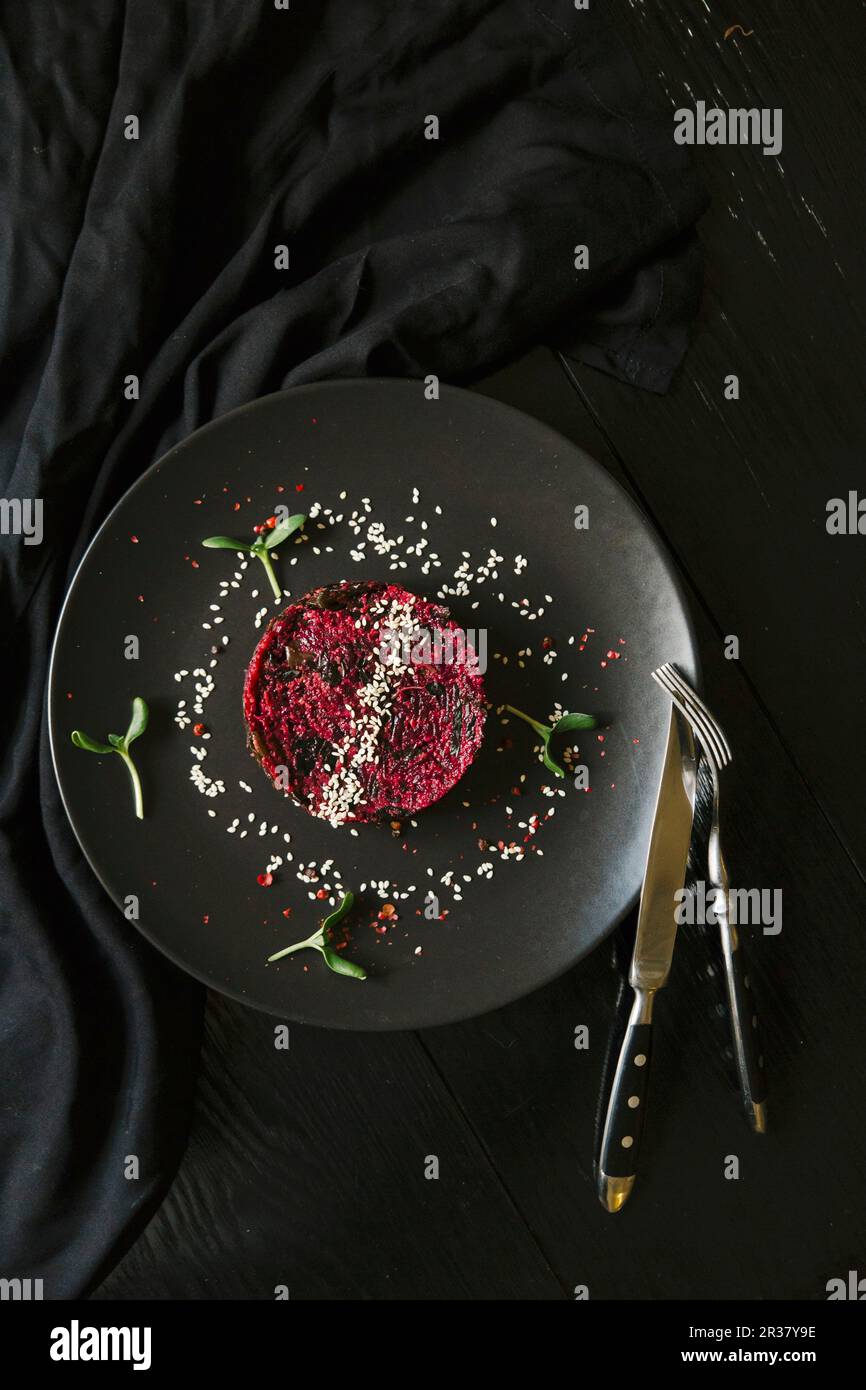 Beetroot tartlet with sesame seeds and cress Stock Photo - Alamy