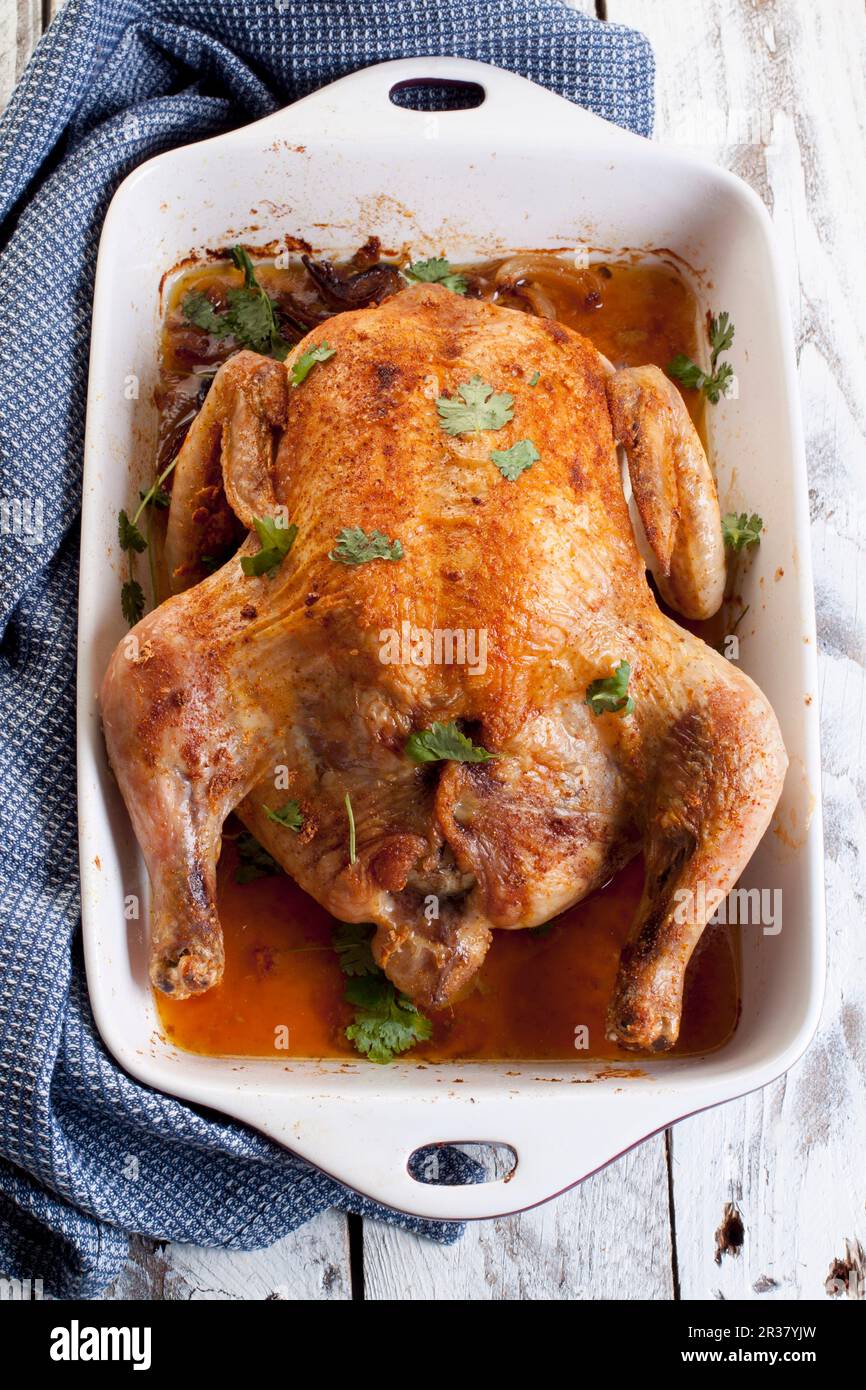 Roast chicken in a dish Stock Photo - Alamy