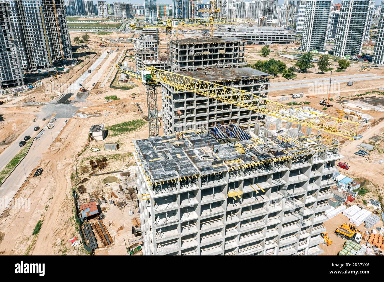 aerial view of working cranes on construction site. new urban ...