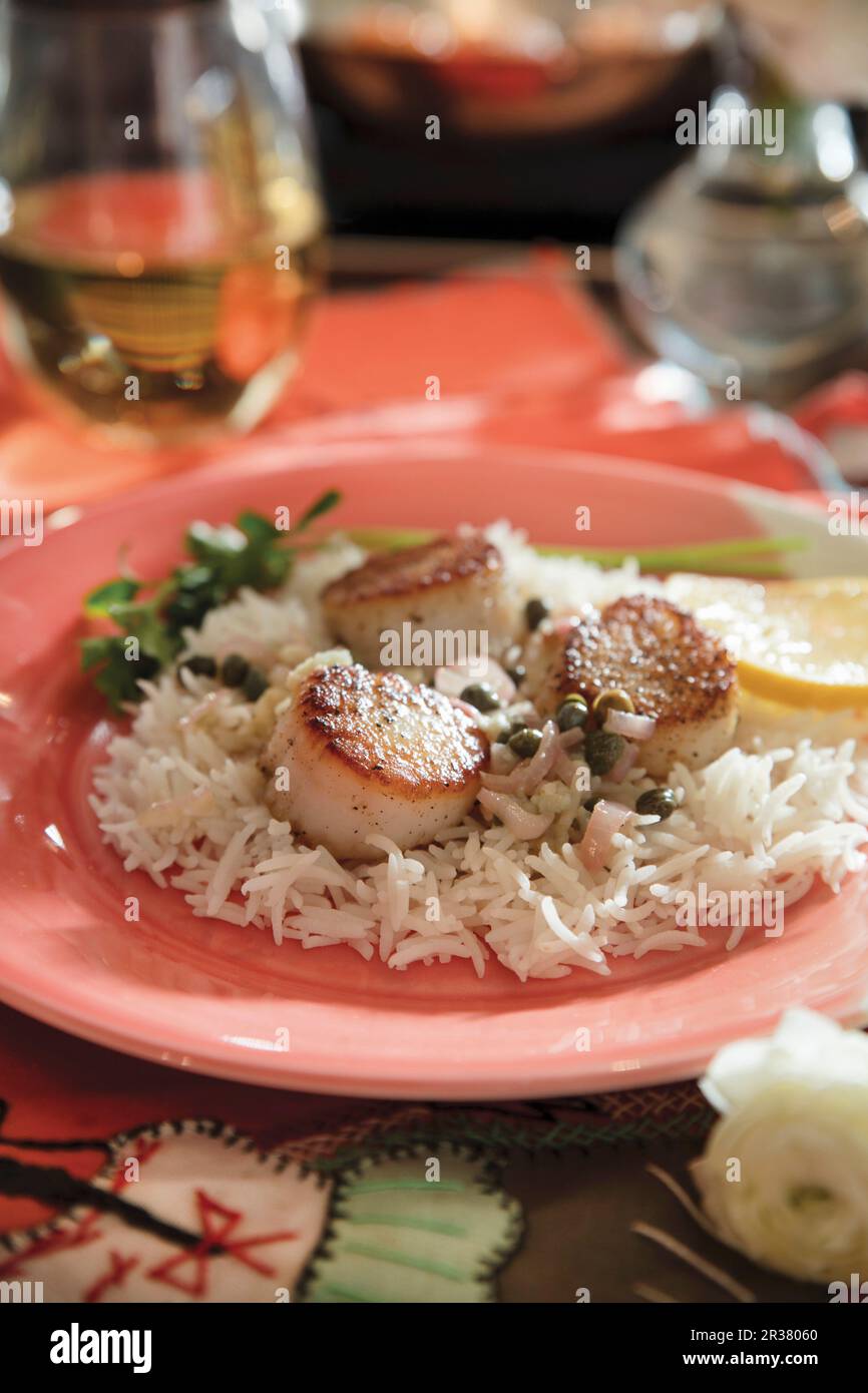 Fried scallops with capers on rice Stock Photo - Alamy