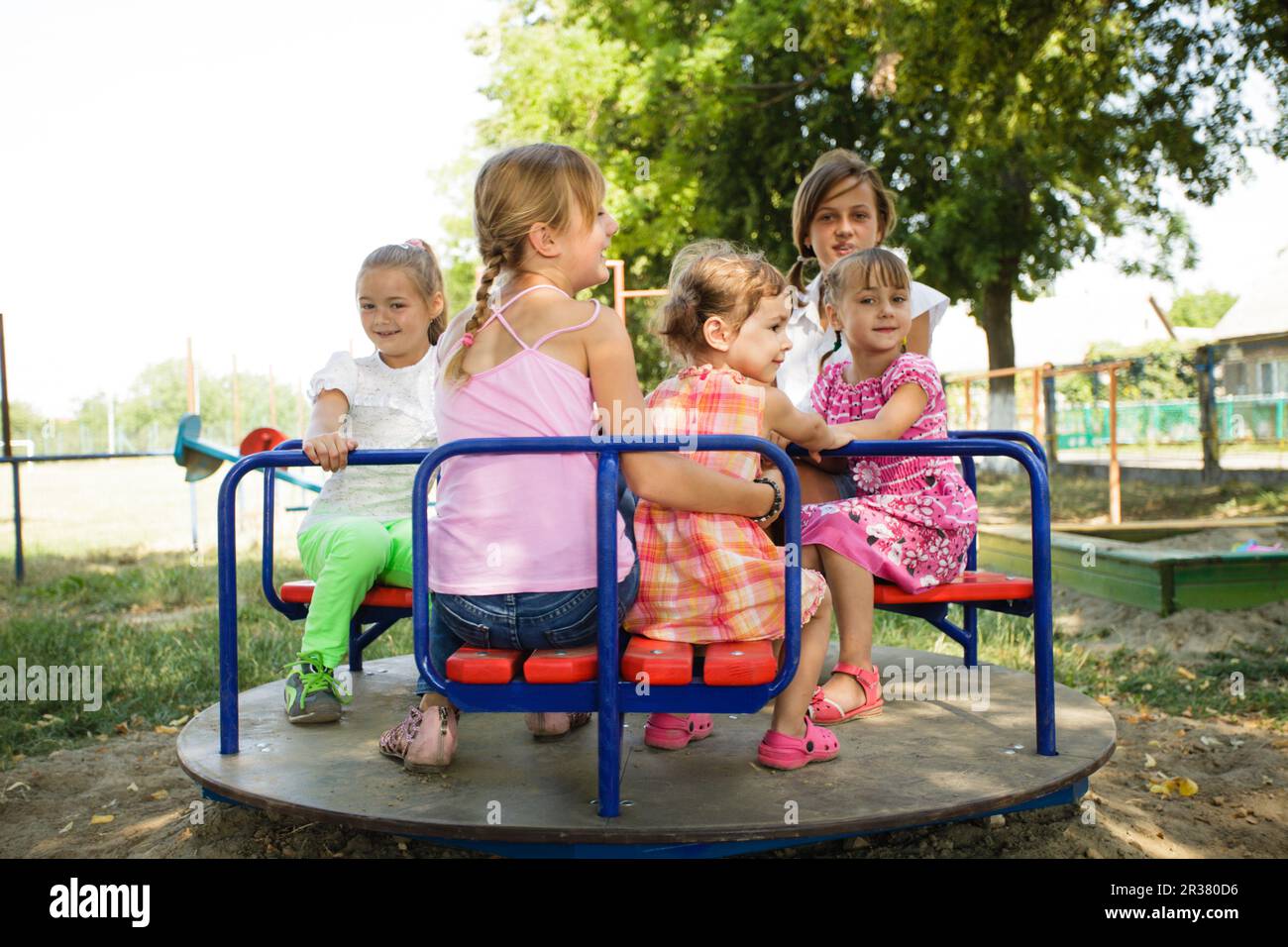 Two sisters on the carousel Stock Photo - Alamy