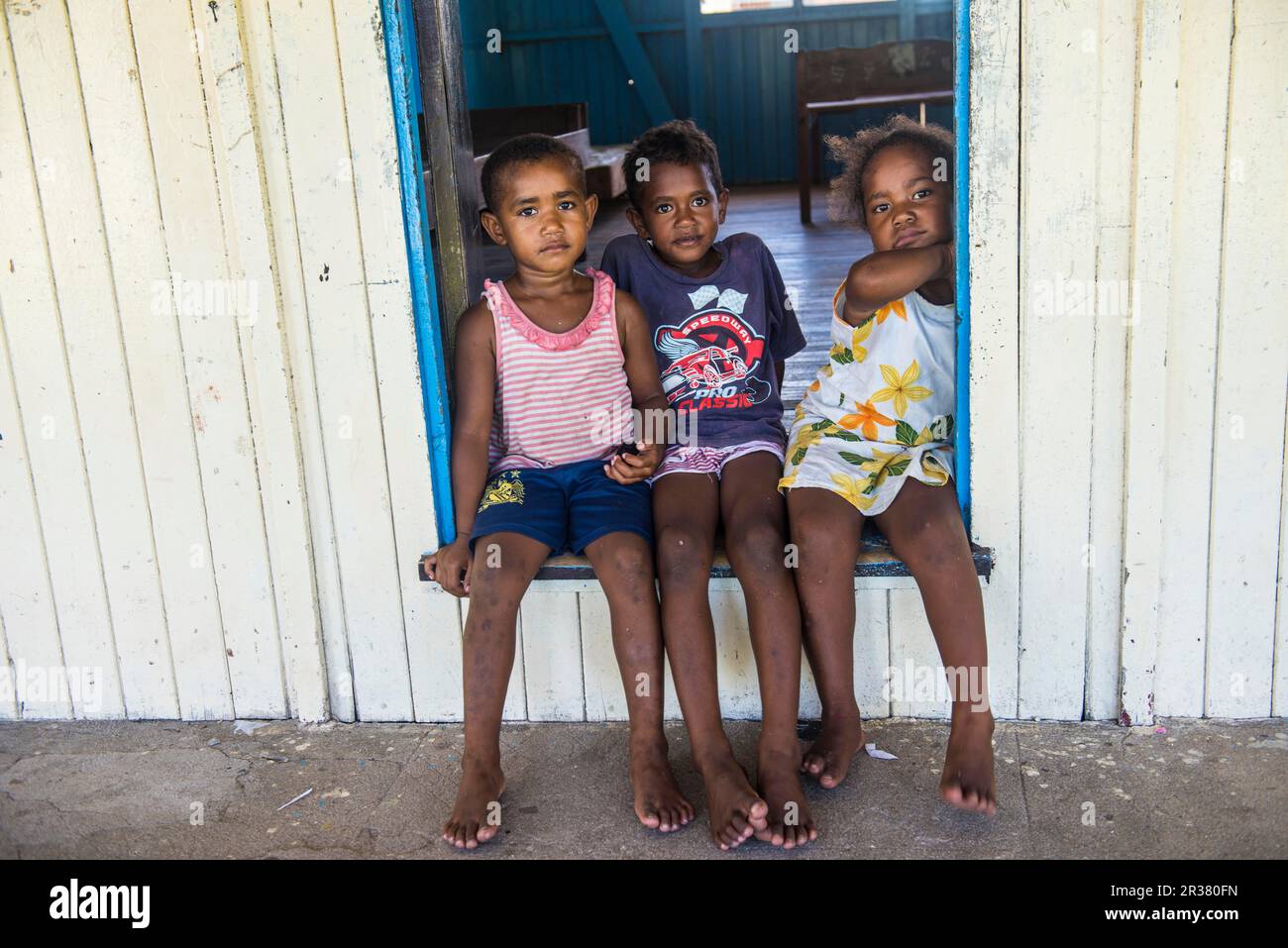 School kids sitting in the entrance of a school, Yanuya island ...