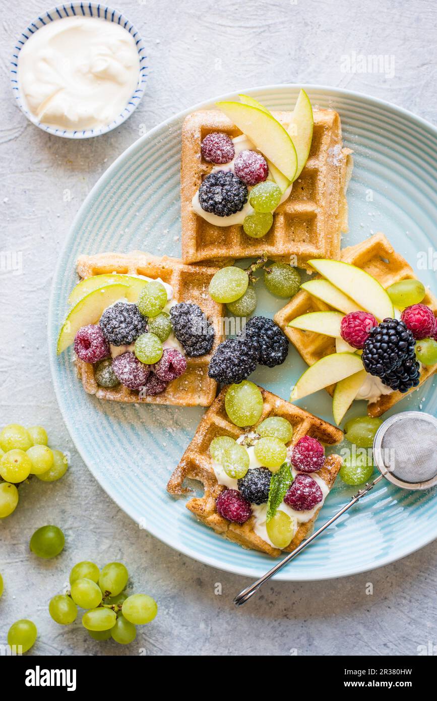 Waffles with fruit and powdered sugar Stock Photo - Alamy
