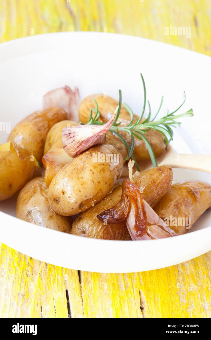 Potatoes boiled in their skins with garlic and rosemary Stock Photo - Alamy