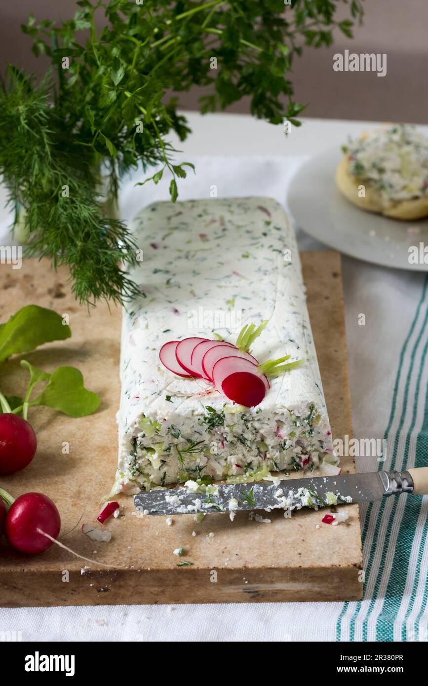 A big piece of quark cheese and herbs terrine on a marble board ...