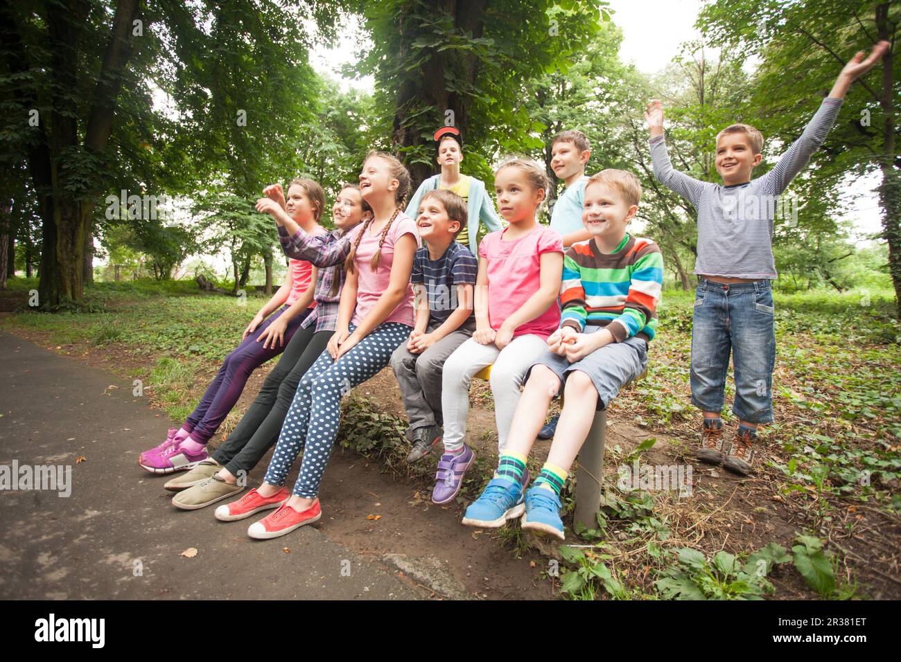 Group of children on a park bench Stock Photo - Alamy
