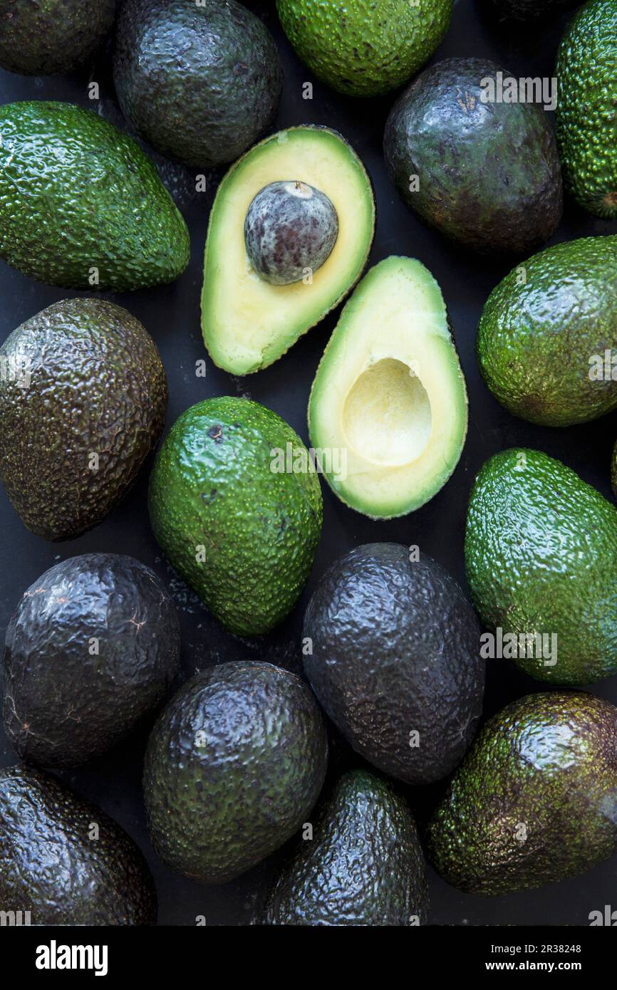 Avocados, one halved Stock Photo - Alamy