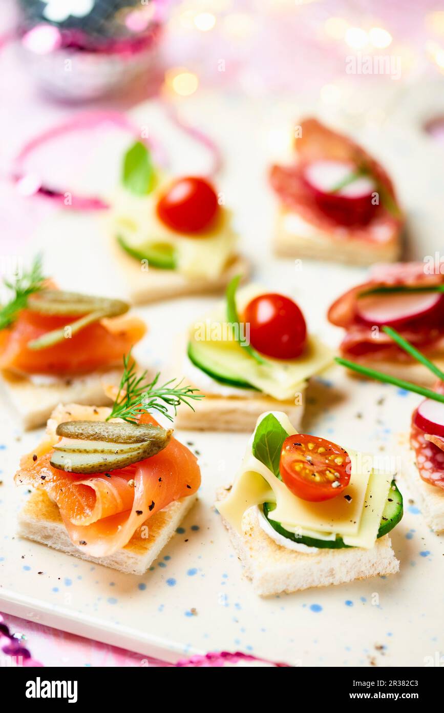 Various canapes with smoked salmon, cheese and salami for Christmas ...