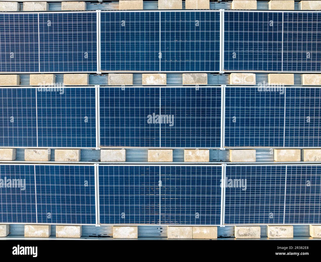 Aerial photo solar panels install on a flat commercial, industrial roof ...